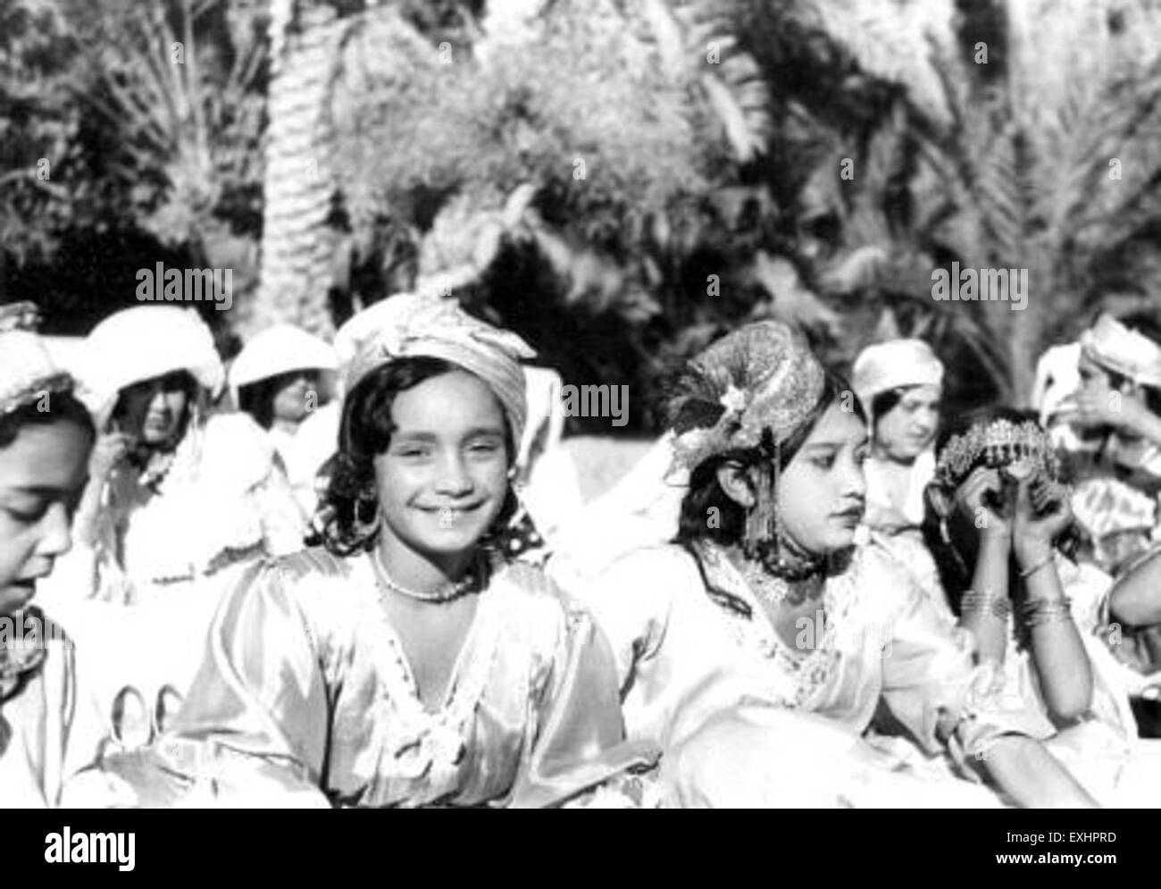 This image captures Arab women at an oasis in Algeria, reflecting the ...