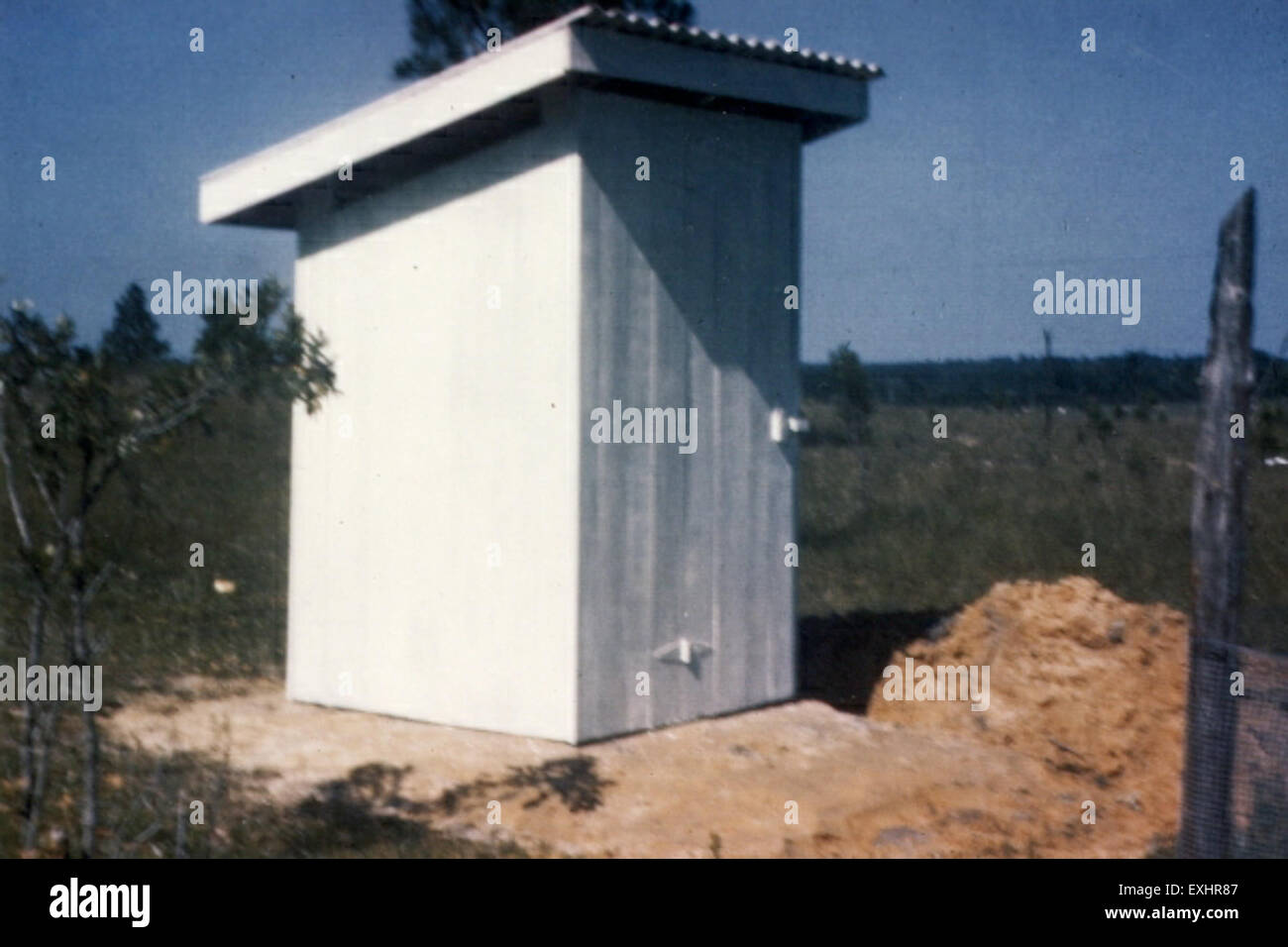 This image depicts a newly built privy from circa 1946, showcasing post ...