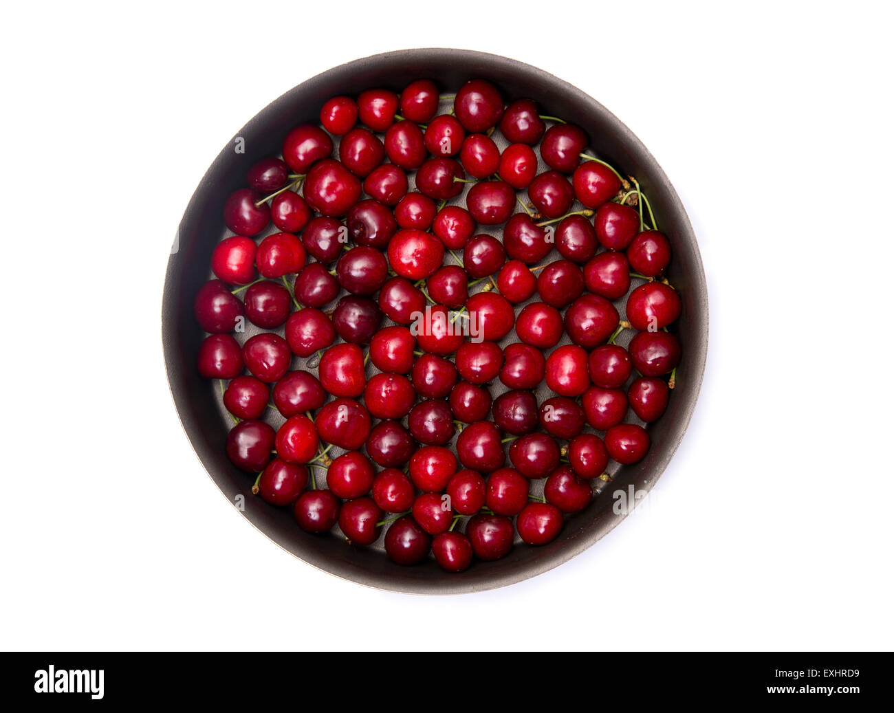 Top view of red cherry in round baking tin, isolated on white ...