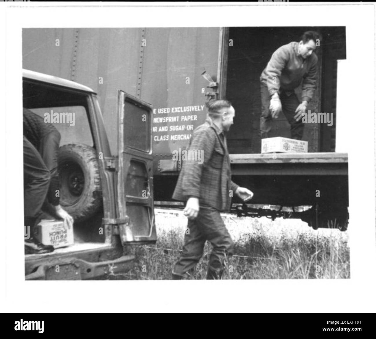 This historical photograph captures the unloading of supplies from a ...