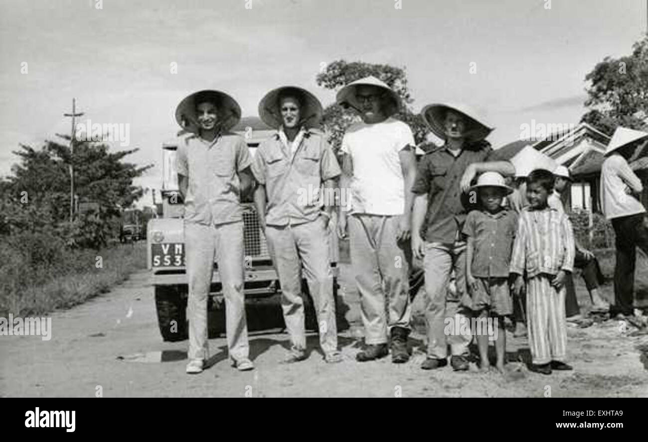 This historical image shows workers at a work camp, likely during a ...