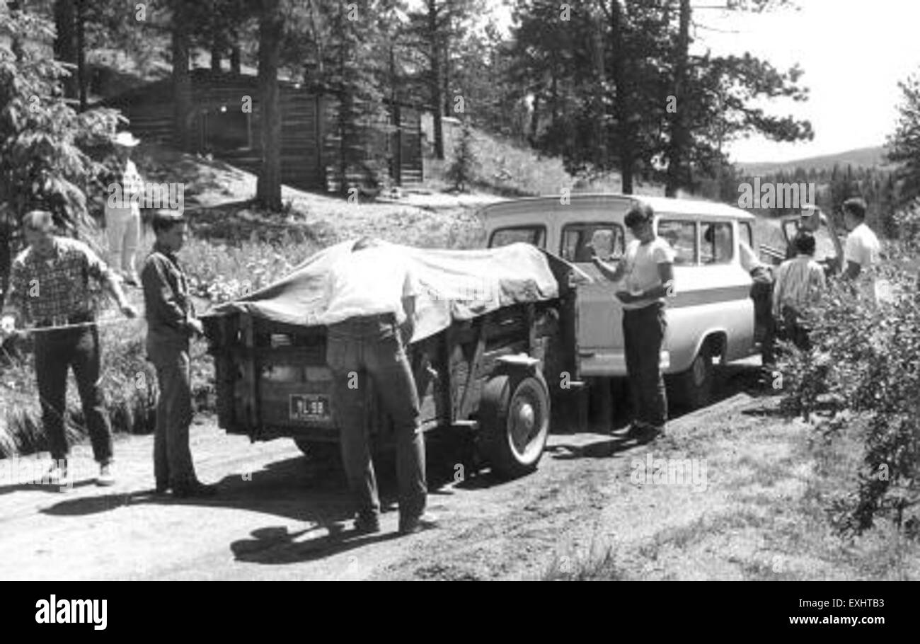 This image features a van equipped with a carry-all unit, typically ...