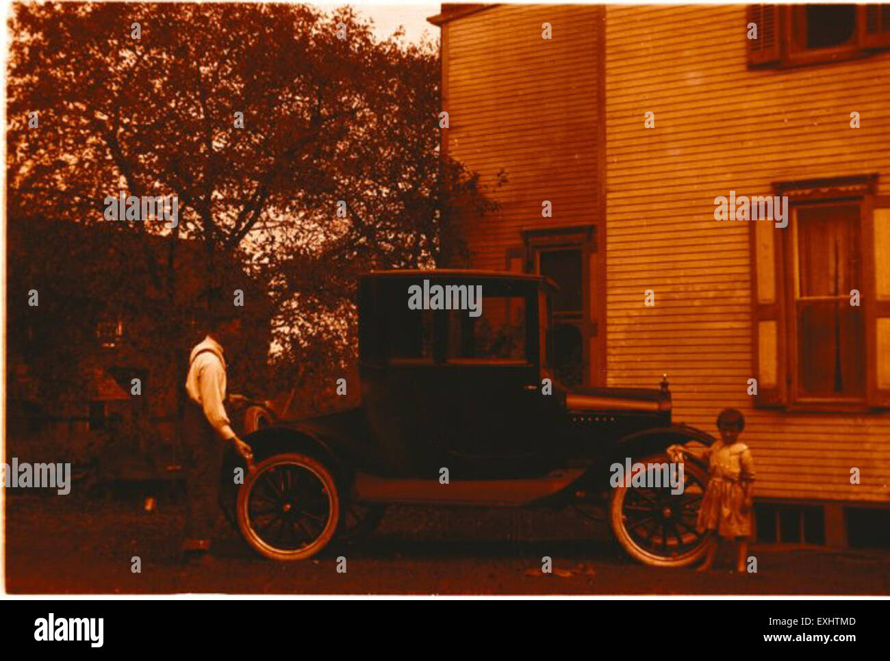 A photograph of Orie O. Miller and Paul Erb washing a car, showcasing ...