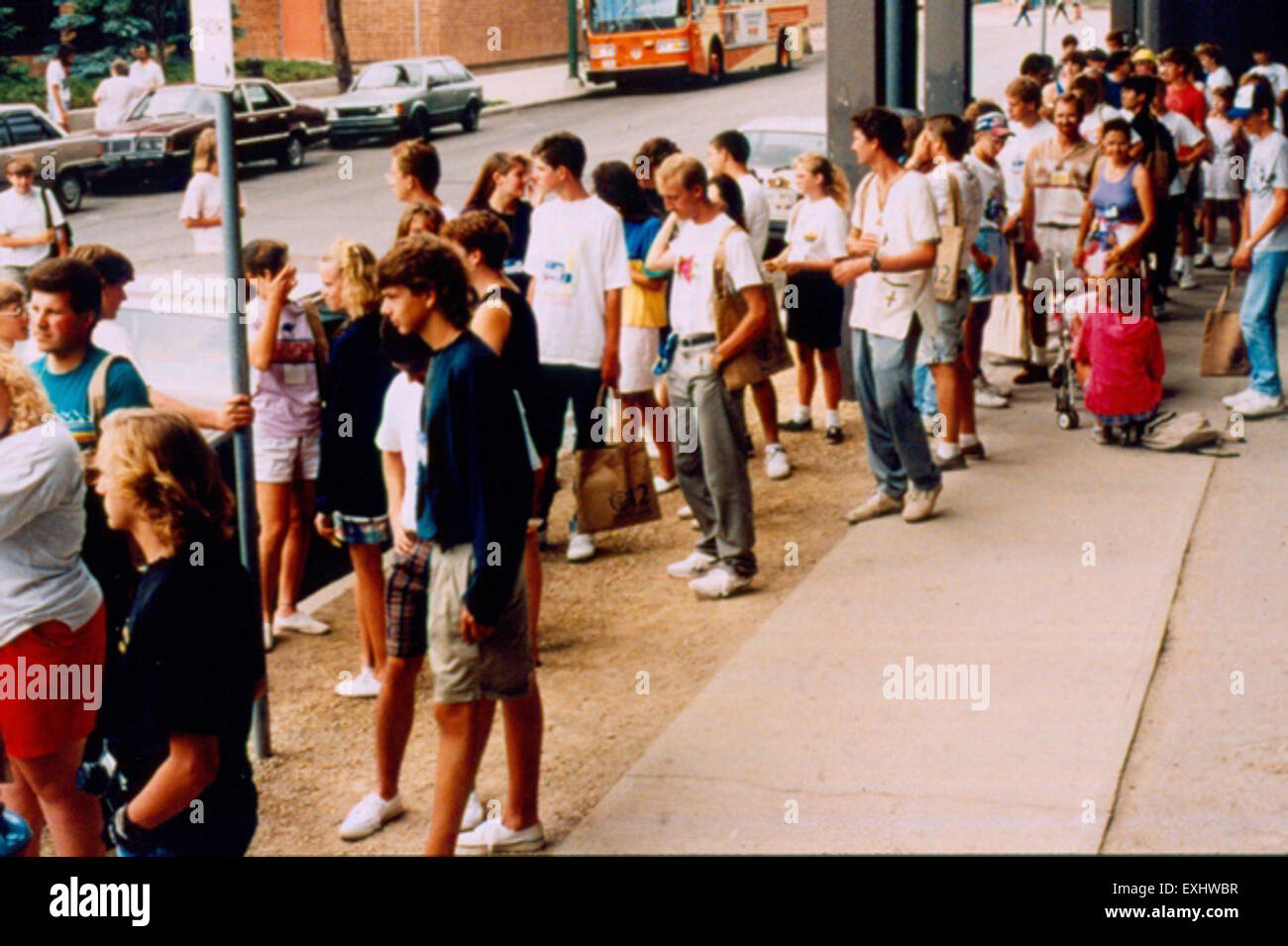 This image depicts youth at a bus stop during the Mennonite World ...