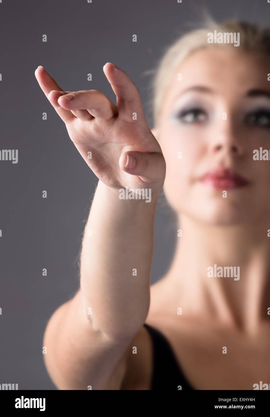 Portrait of a beautiful female ballet dancer on a grey background ...