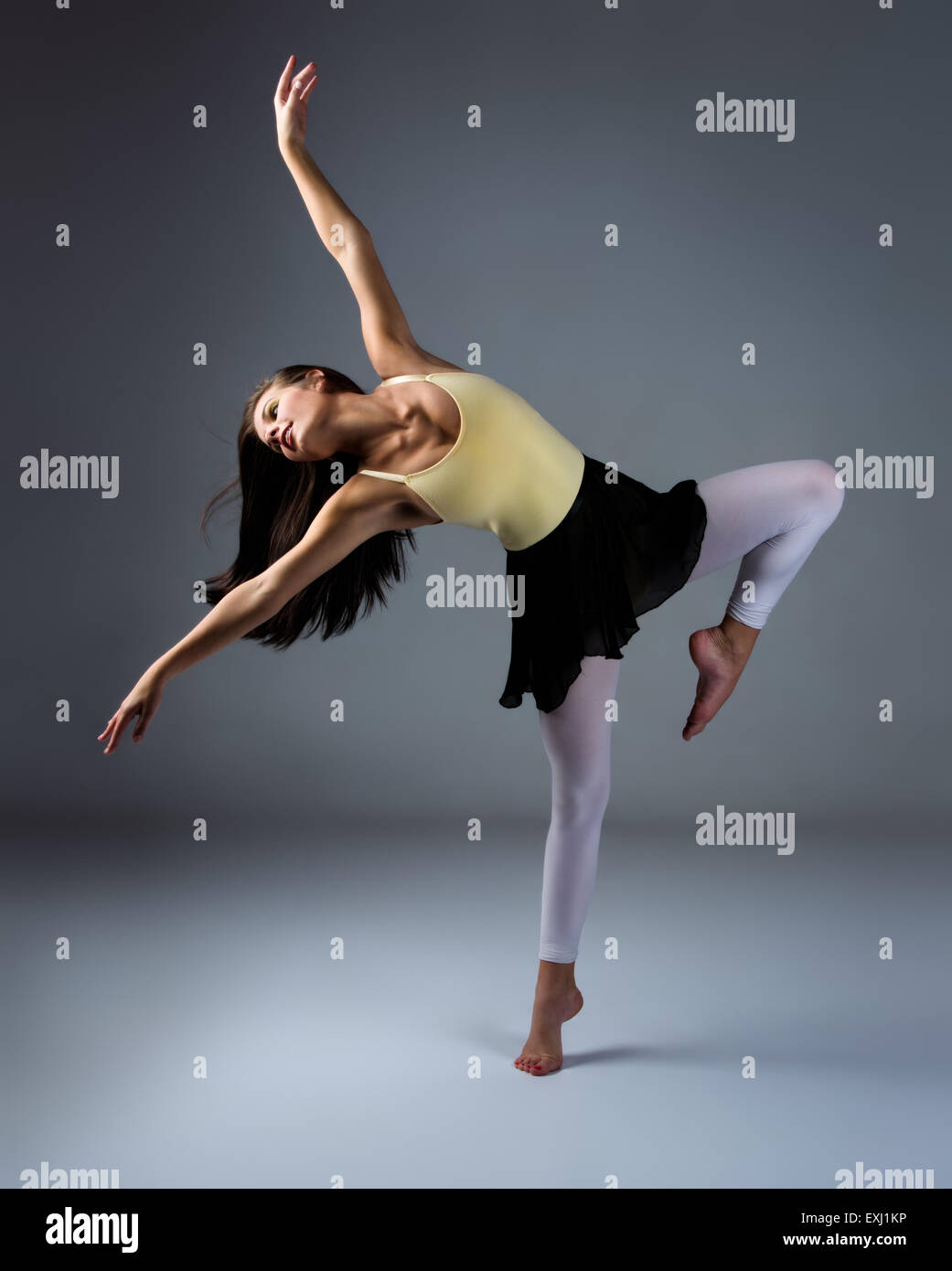 Beautiful female modern jazz contemporary style dancer on a grey ...