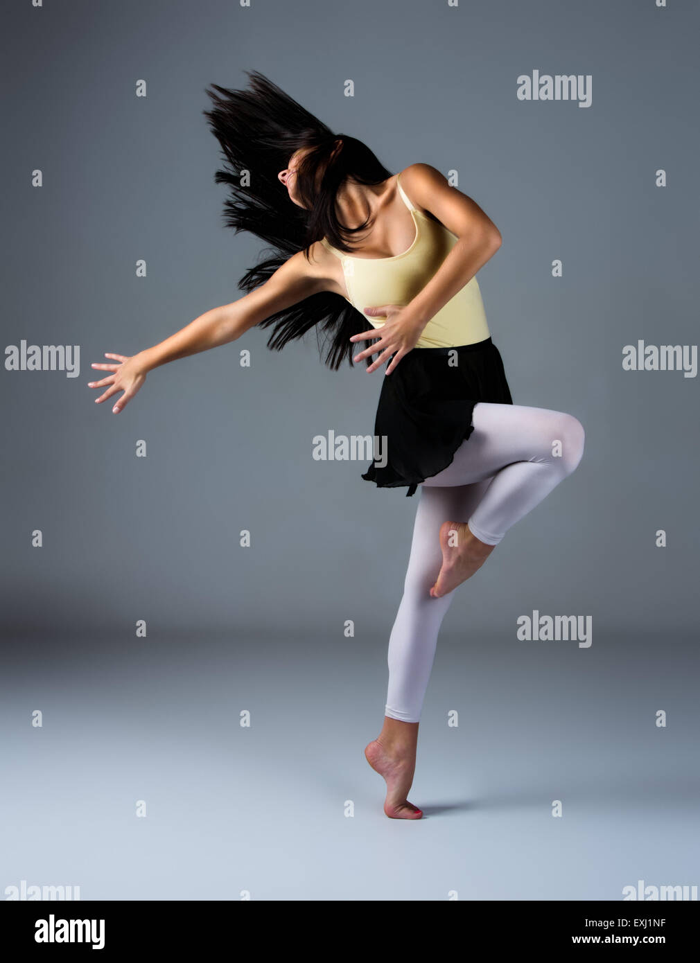 Beautiful female modern jazz contemporary style dancer on a grey ...