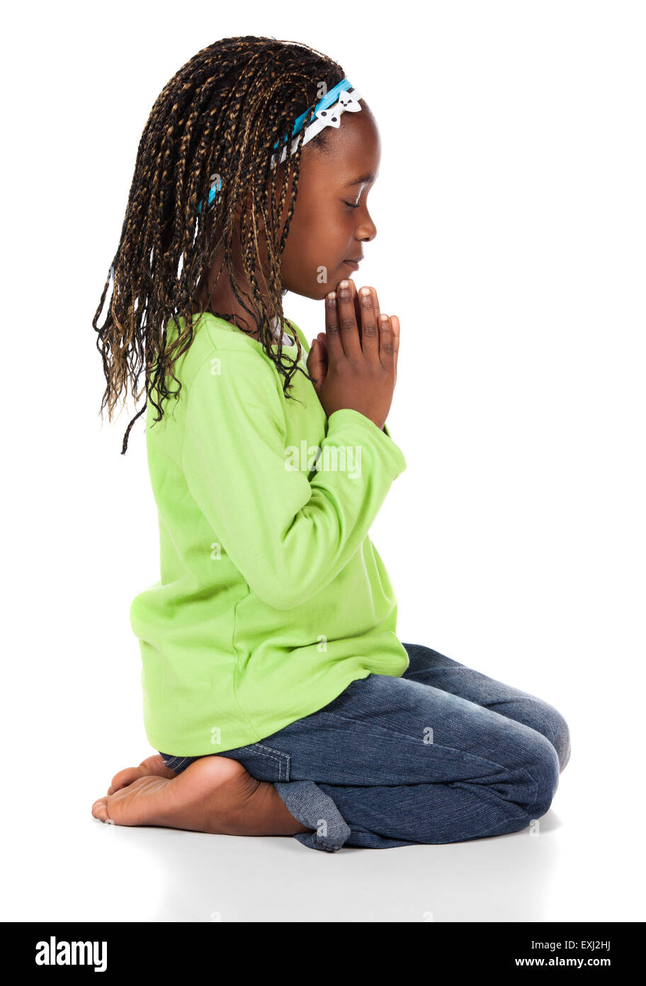 Adorable small african child with braids wearing a bright green shirt ...