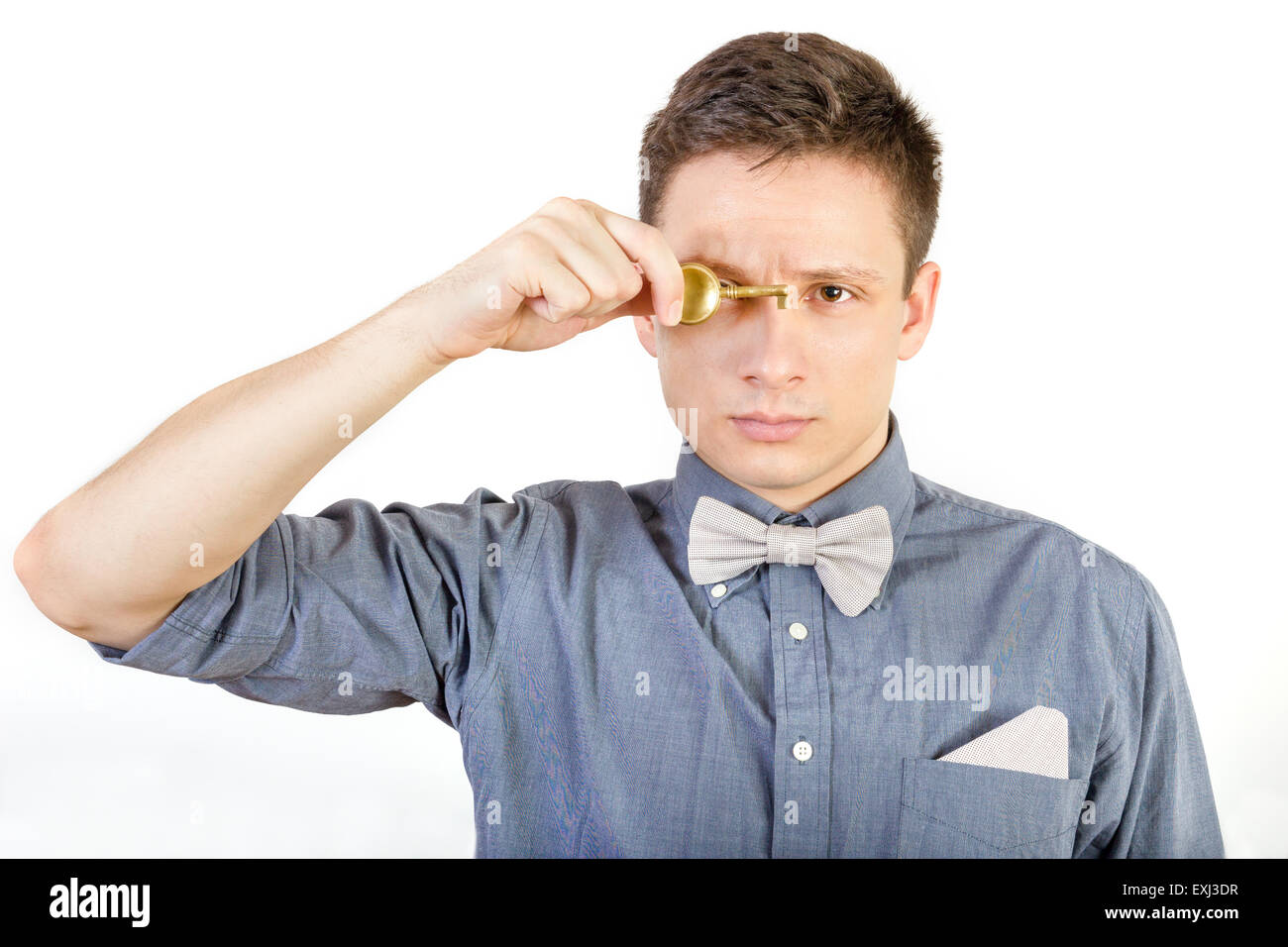 Young serious man in shirt and bow tie holds door locker. Male person ...