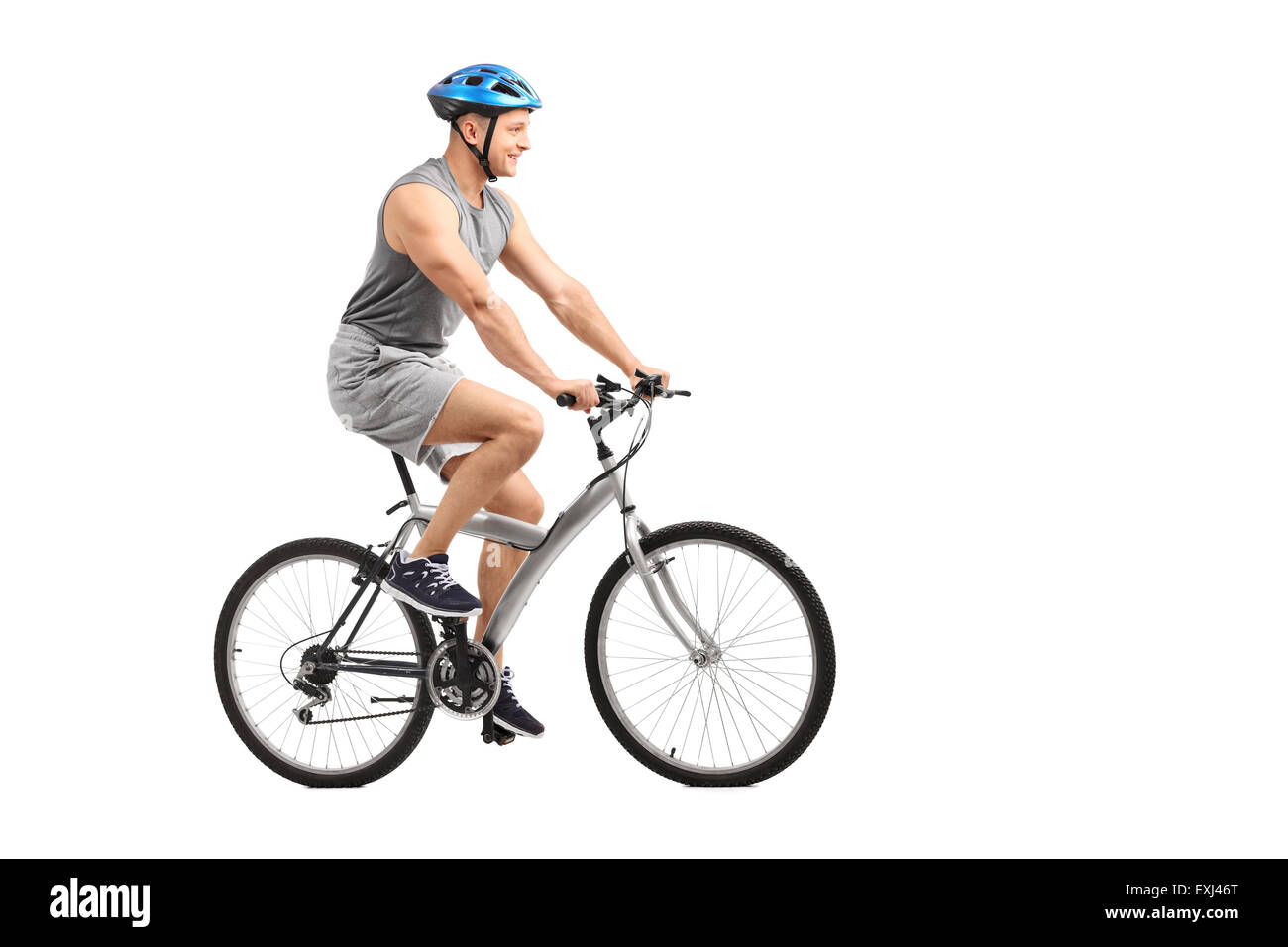 Full length profile shot of a young male biker riding a bicycle ...