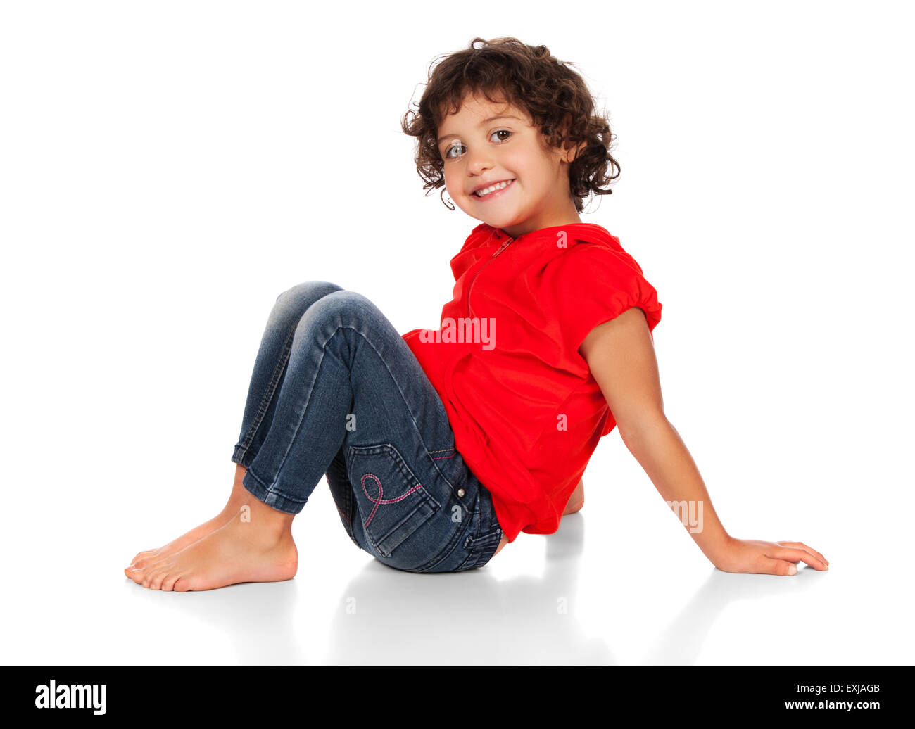 Adorable small caucasian child with curly hair wearing a bright red ...
