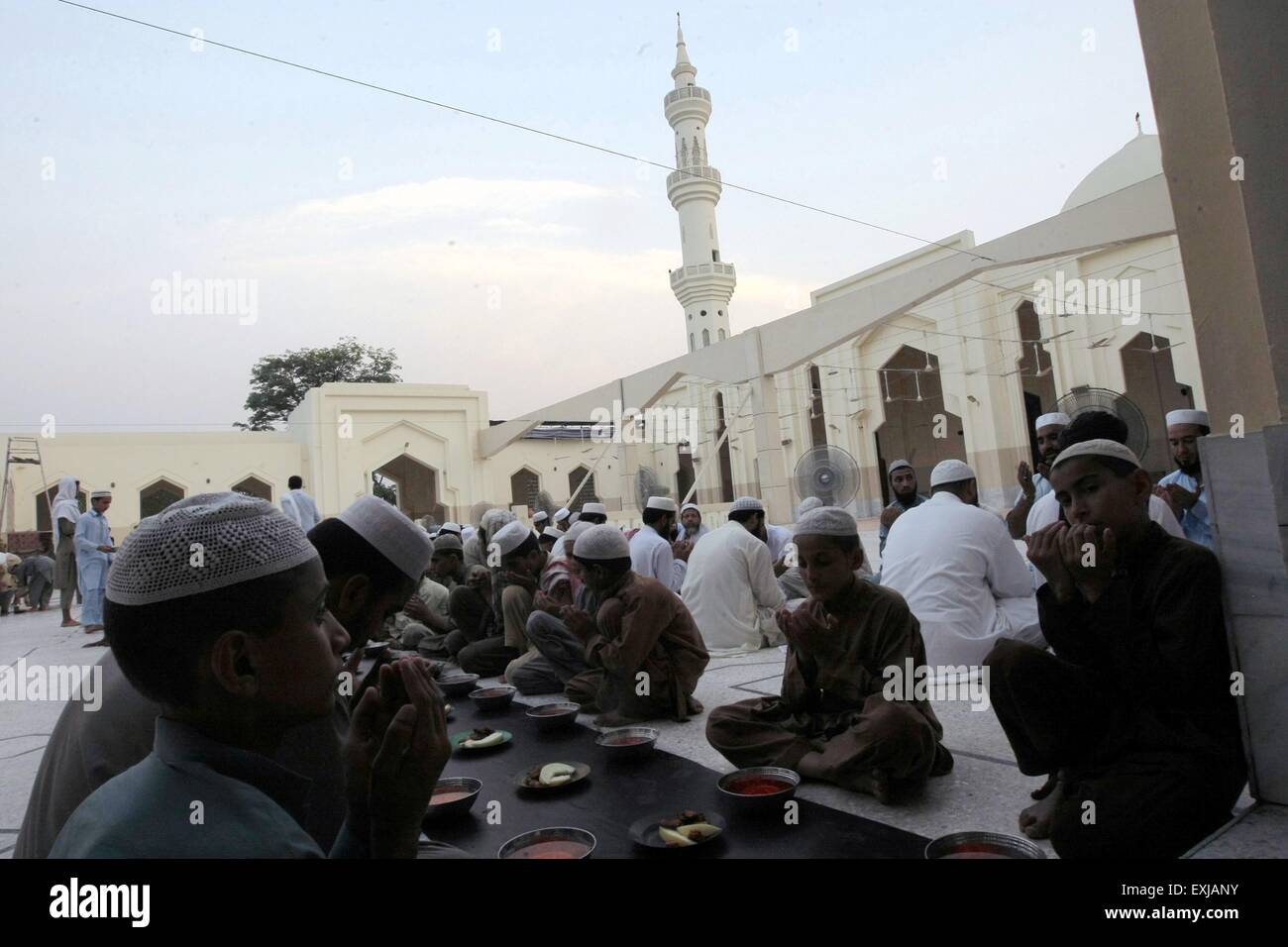 Peshawar. 14th July, 2015. Pakistani Muslims pray before breaking their ...