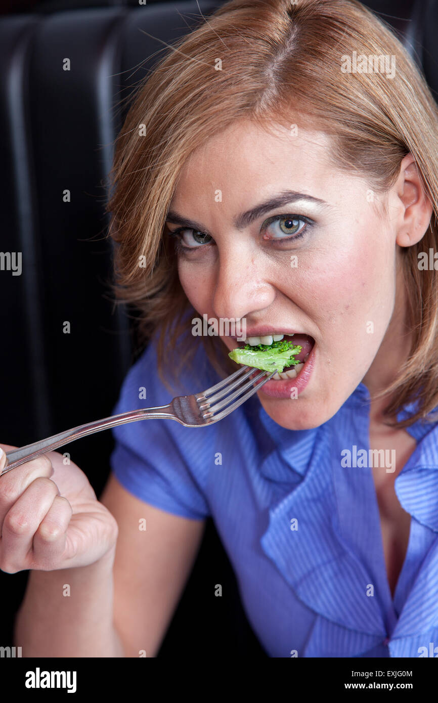 Woman eating some vegetables Stock Photo - Alamy