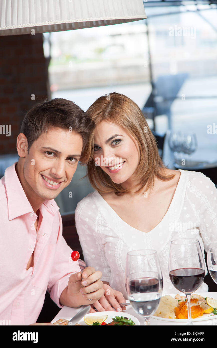 Couple in love eating at restaurant Stock Photo - Alamy