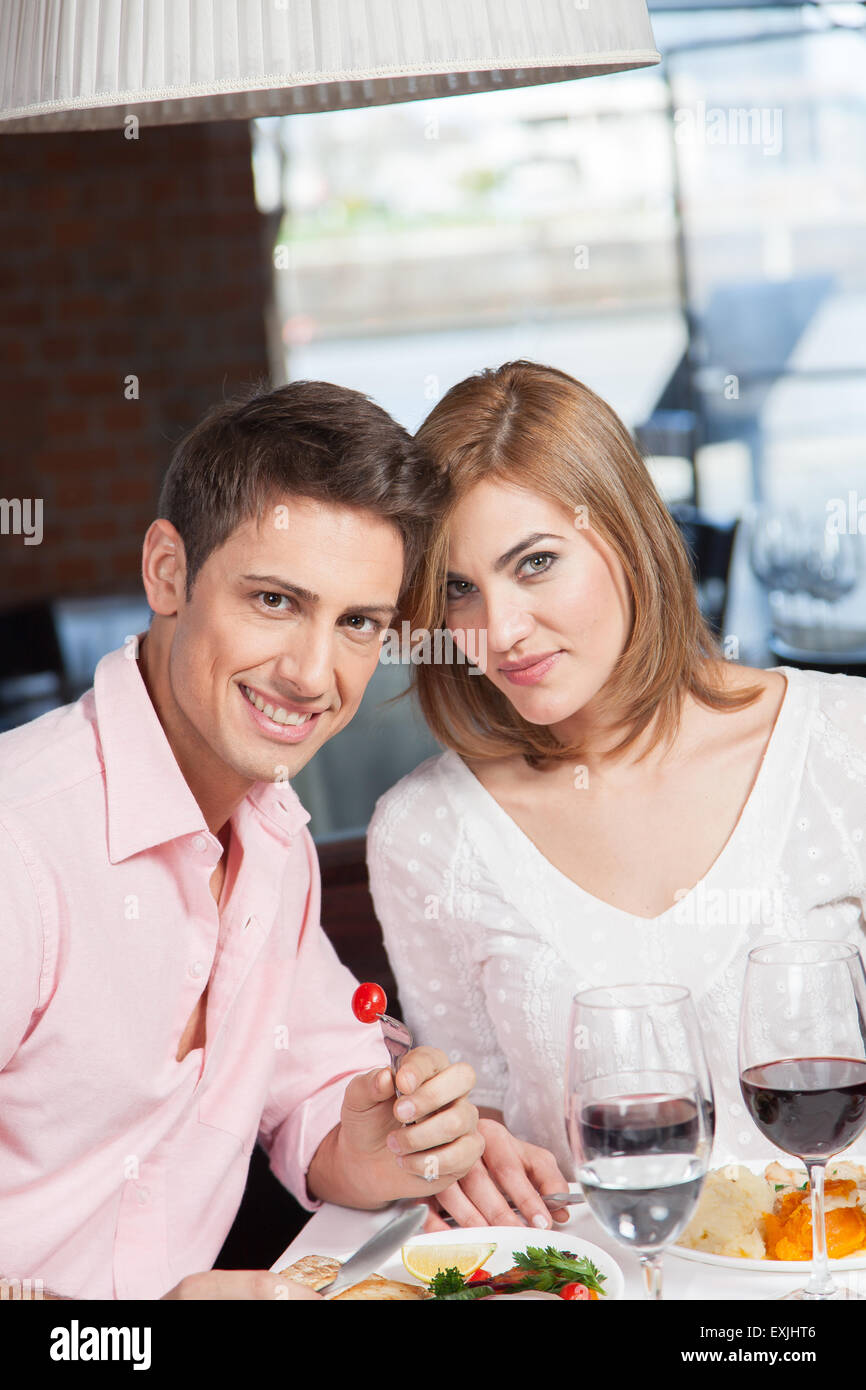 Couple in love eating at restaurant Stock Photo - Alamy