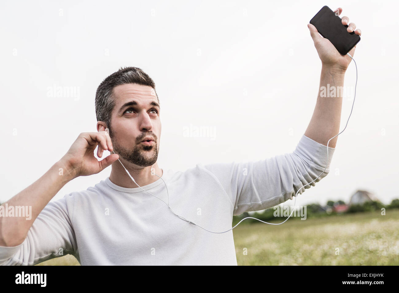 Happy young man in a field Stock Photo - Alamy