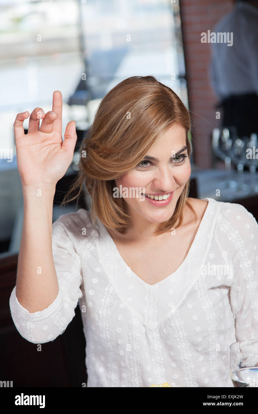 Woman calling the waiter Stock Photo - Alamy