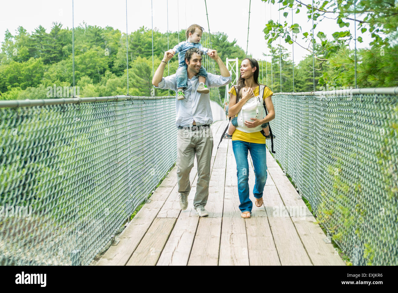 Family having fun on a small bridge Stock Photo - Alamy