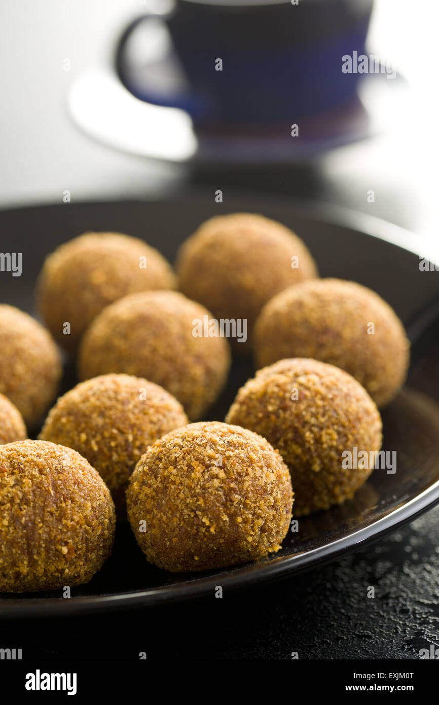 sweet truffles on black plate Stock Photo - Alamy