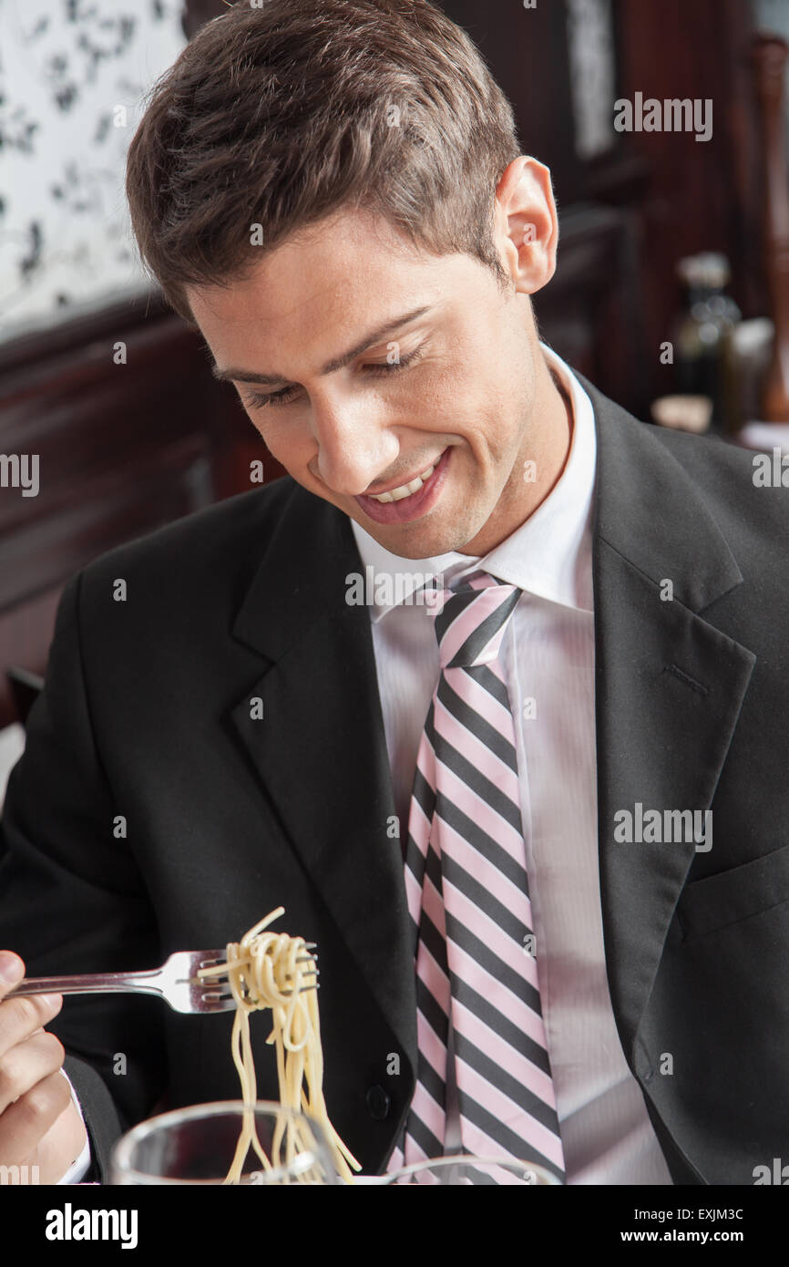 Happy man eating spaghetti Stock Photo - Alamy