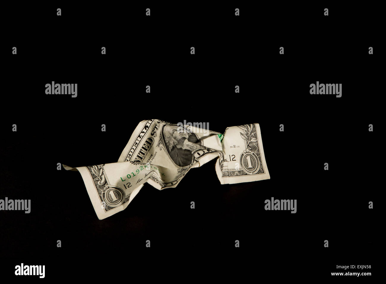 Crumpled American dollar bill on a black background Stock Photo - Alamy