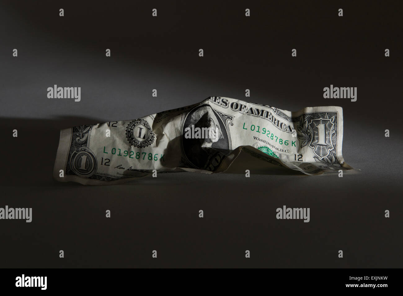 Crumpled American dollar bill on a black background Stock Photo - Alamy
