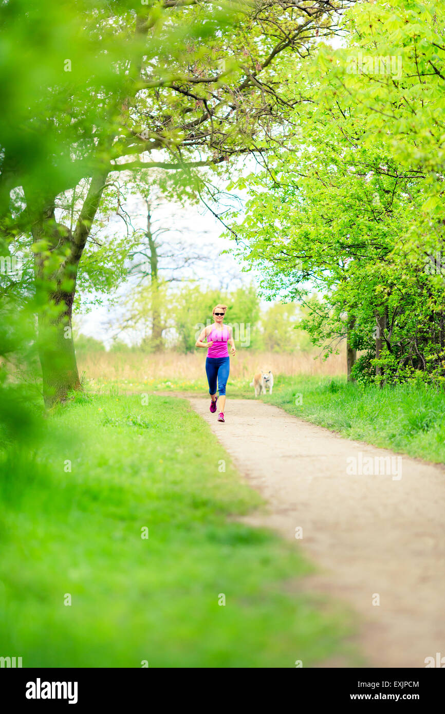 Woman runner running and walking in park, summer nature, exercising in ...