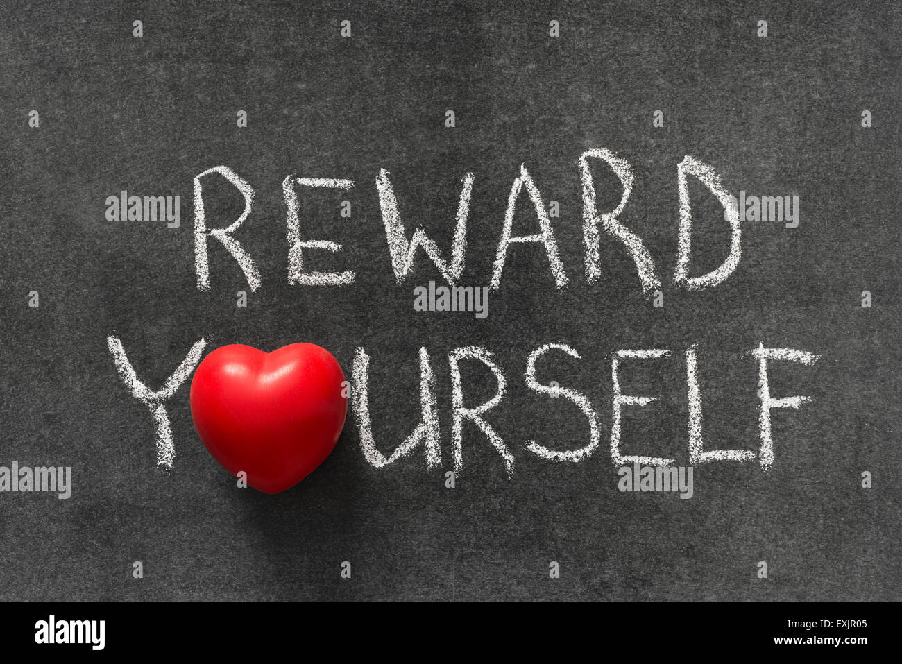 reward yourself phrase handwritten on blackboard with heart symbol ...