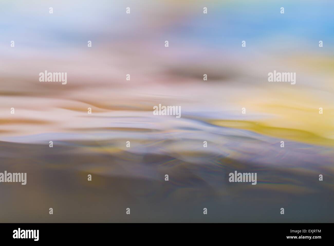 Moving water abstraction. Close up of water surface with colorful ...