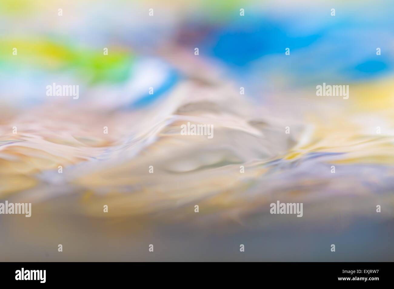 Moving water abstraction. Close up of water surface with colorful ...