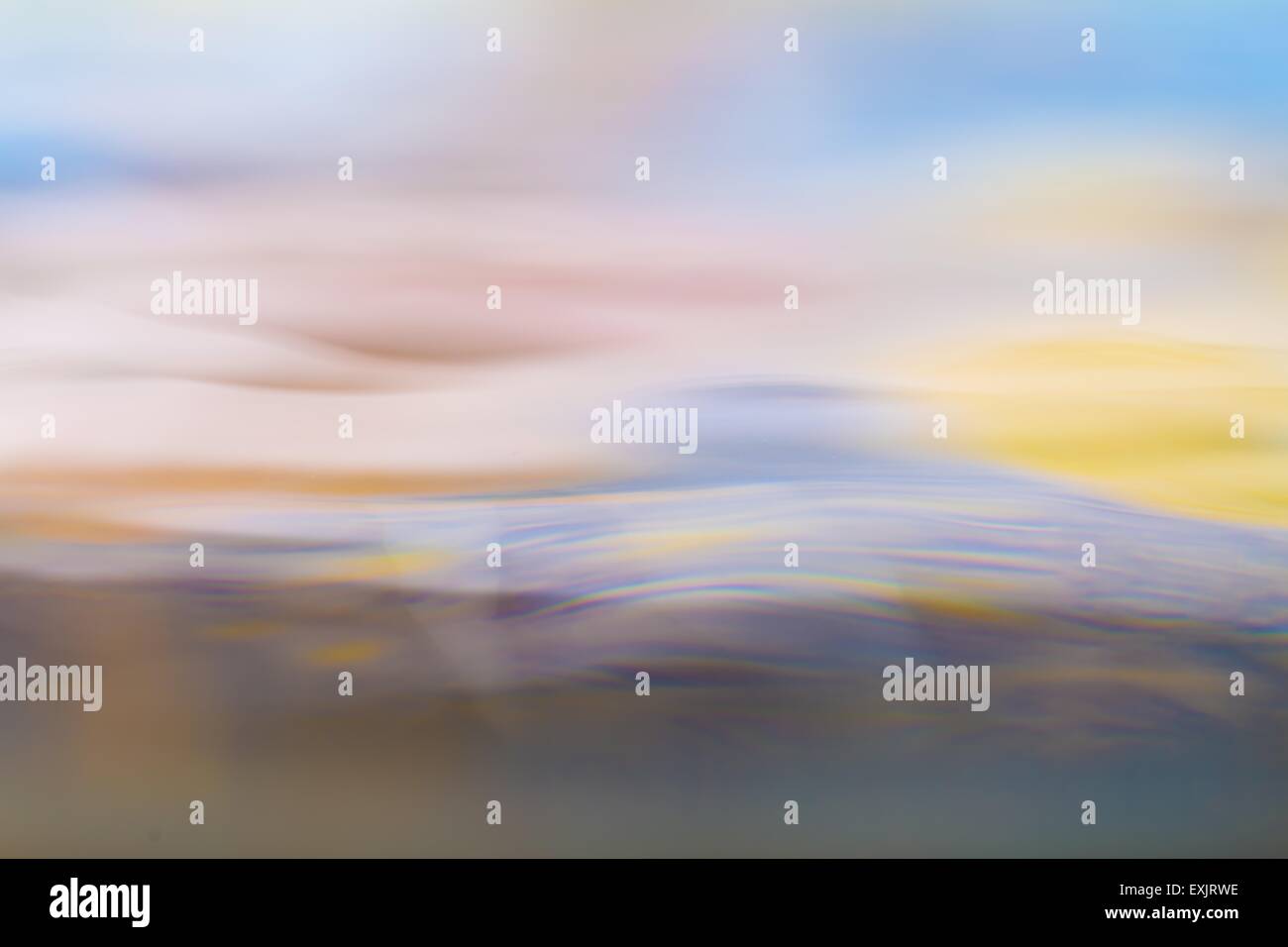 Moving water abstraction. Close up of water surface with colorful ...