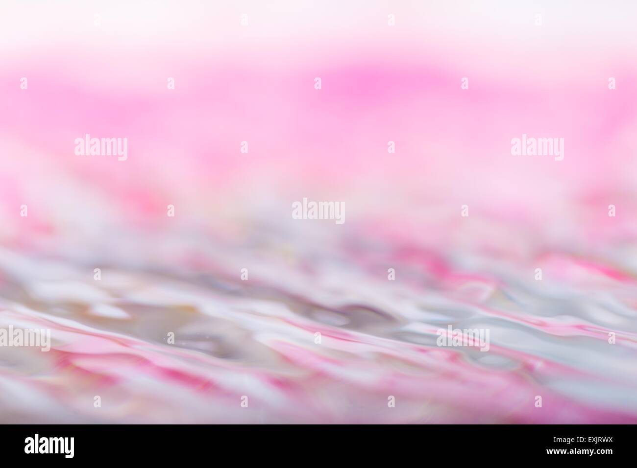 Moving water abstraction. Close up of water surface with colorful ...
