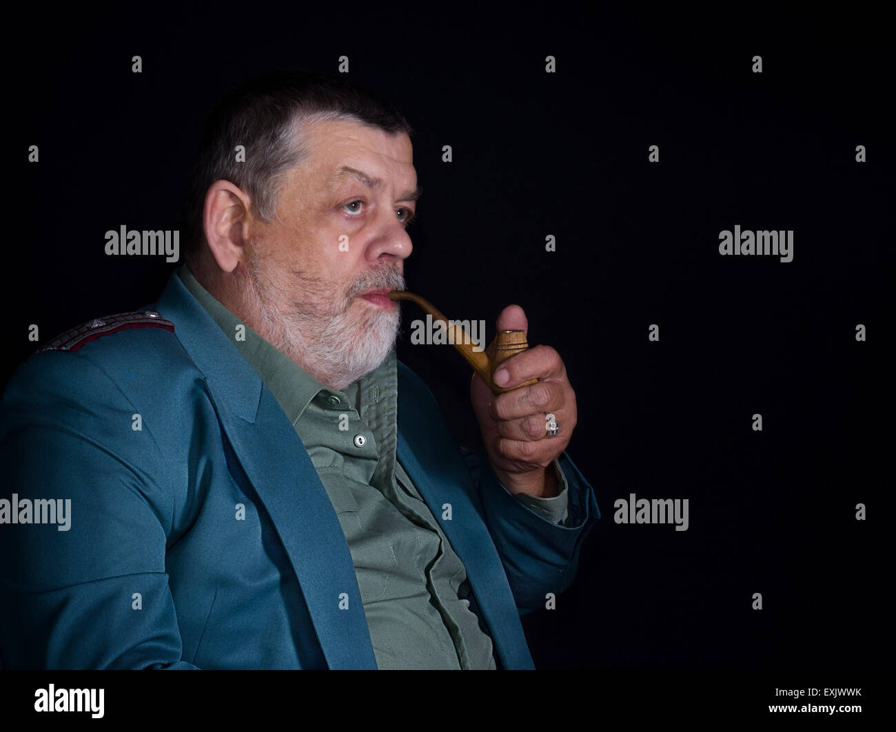 Portrait of military man smoking tobacco-pipe and thinking about ...