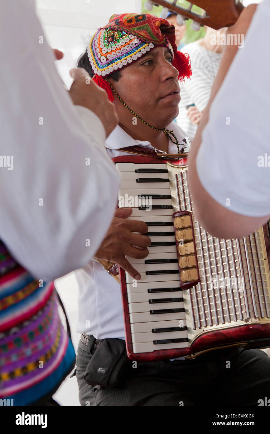 A Quecha man, indigenous Peruvian, in traditional barb playing ...