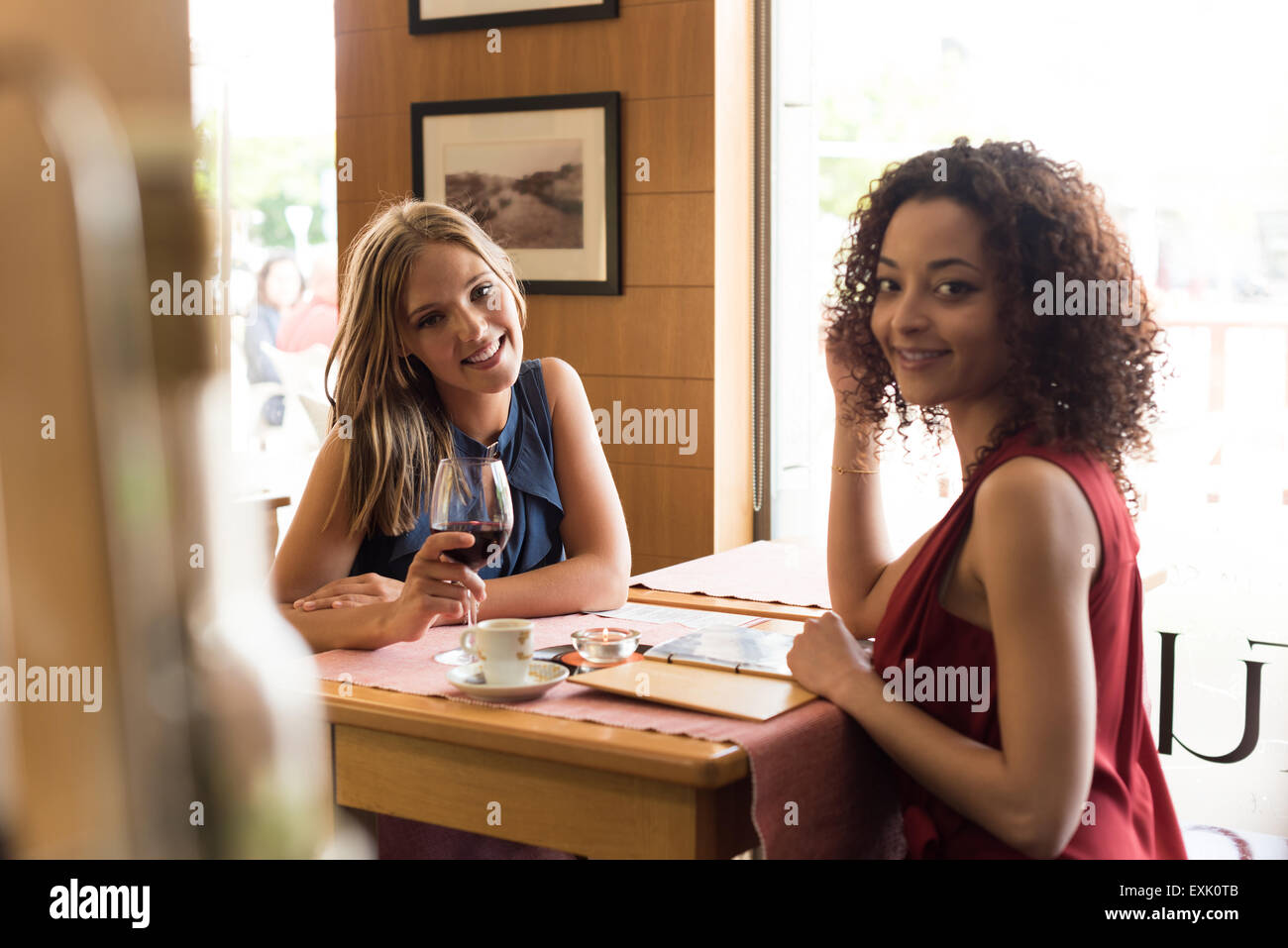 Multi ethnic friends talking and drinking in bar Stock Photo - Alamy