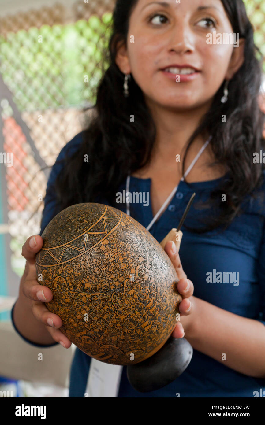 Woman holding Peruvian gourd carving Stock Photo - Alamy