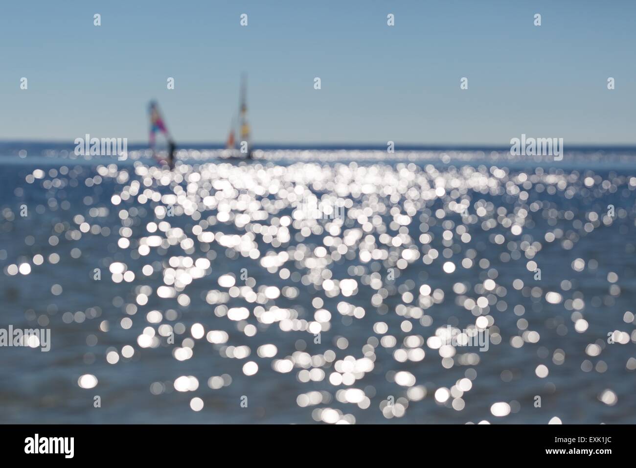 Defocused seascape with windsurfers on sea surface. Blurry landscape ...