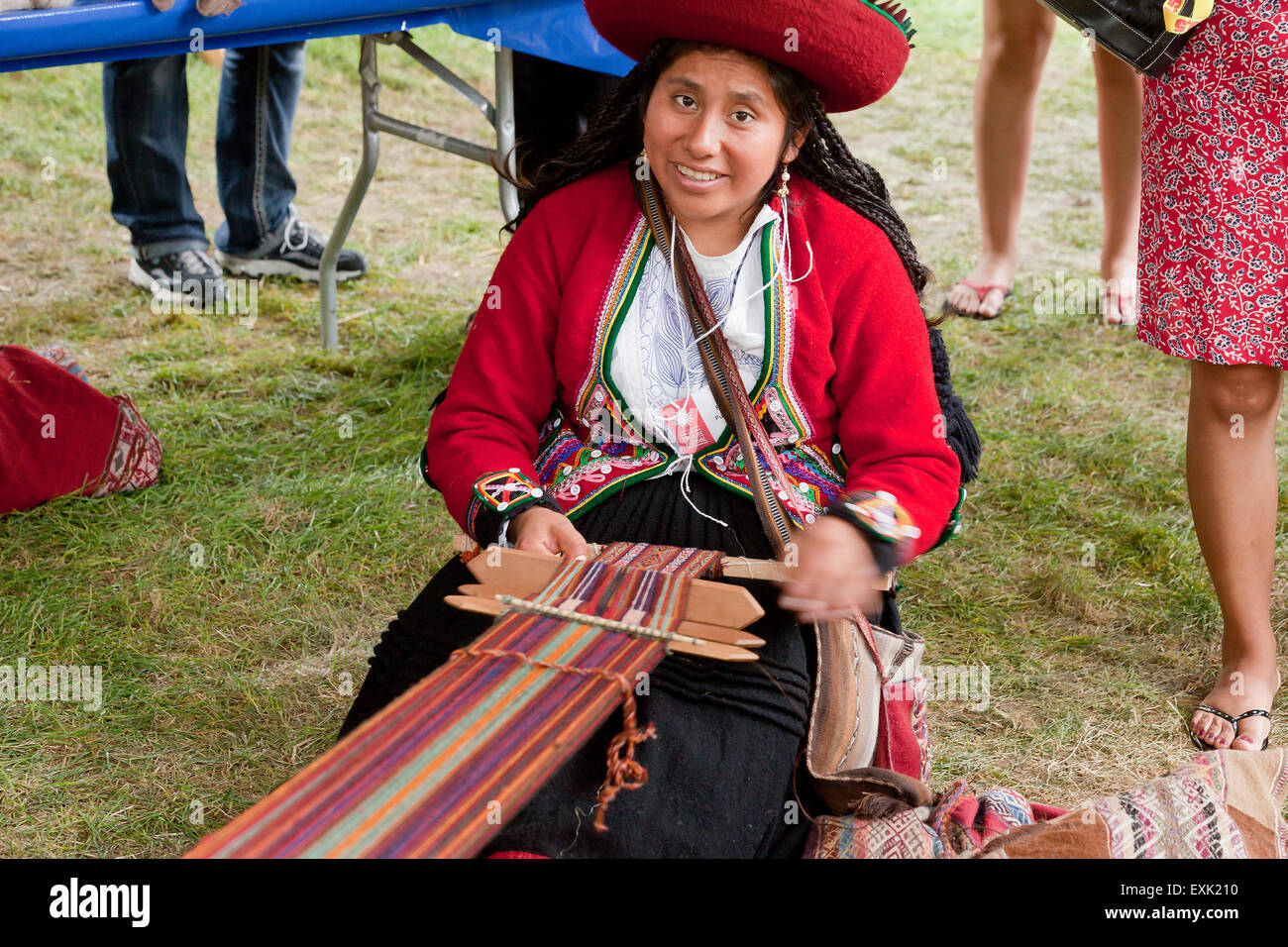 Peruvian woman from Chinchero weaving traditional fabric using a back ...