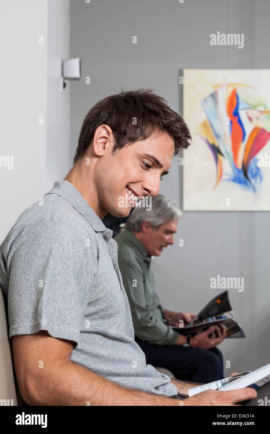 Man waiting his turn in the waiting area Stock Photo - Alamy