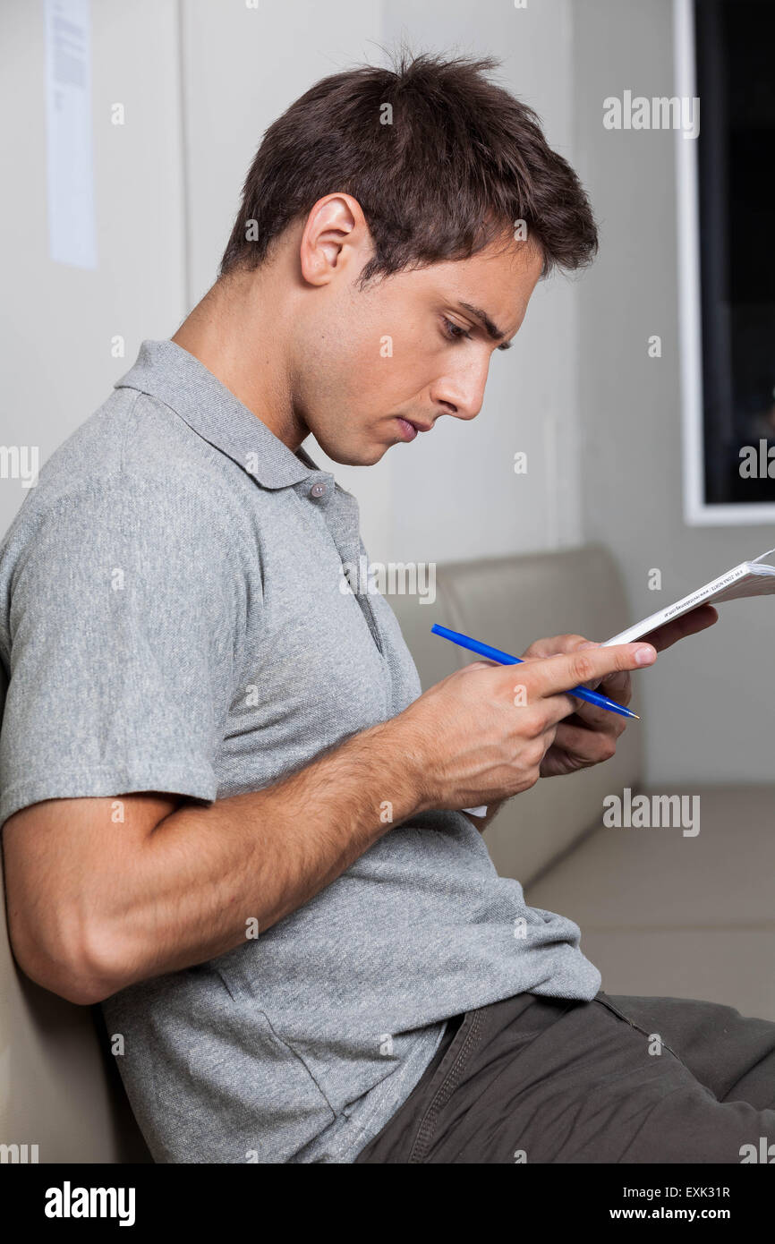 Man waiting his turn in the waiting area Stock Photo - Alamy