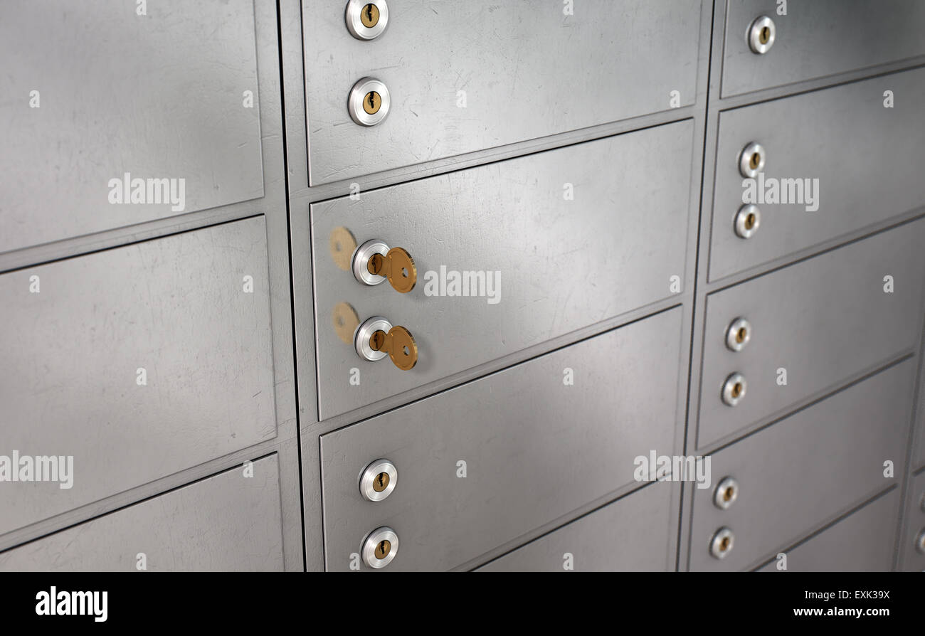 A closeup of a wall of closed metal safety deposit boxes and one with ...