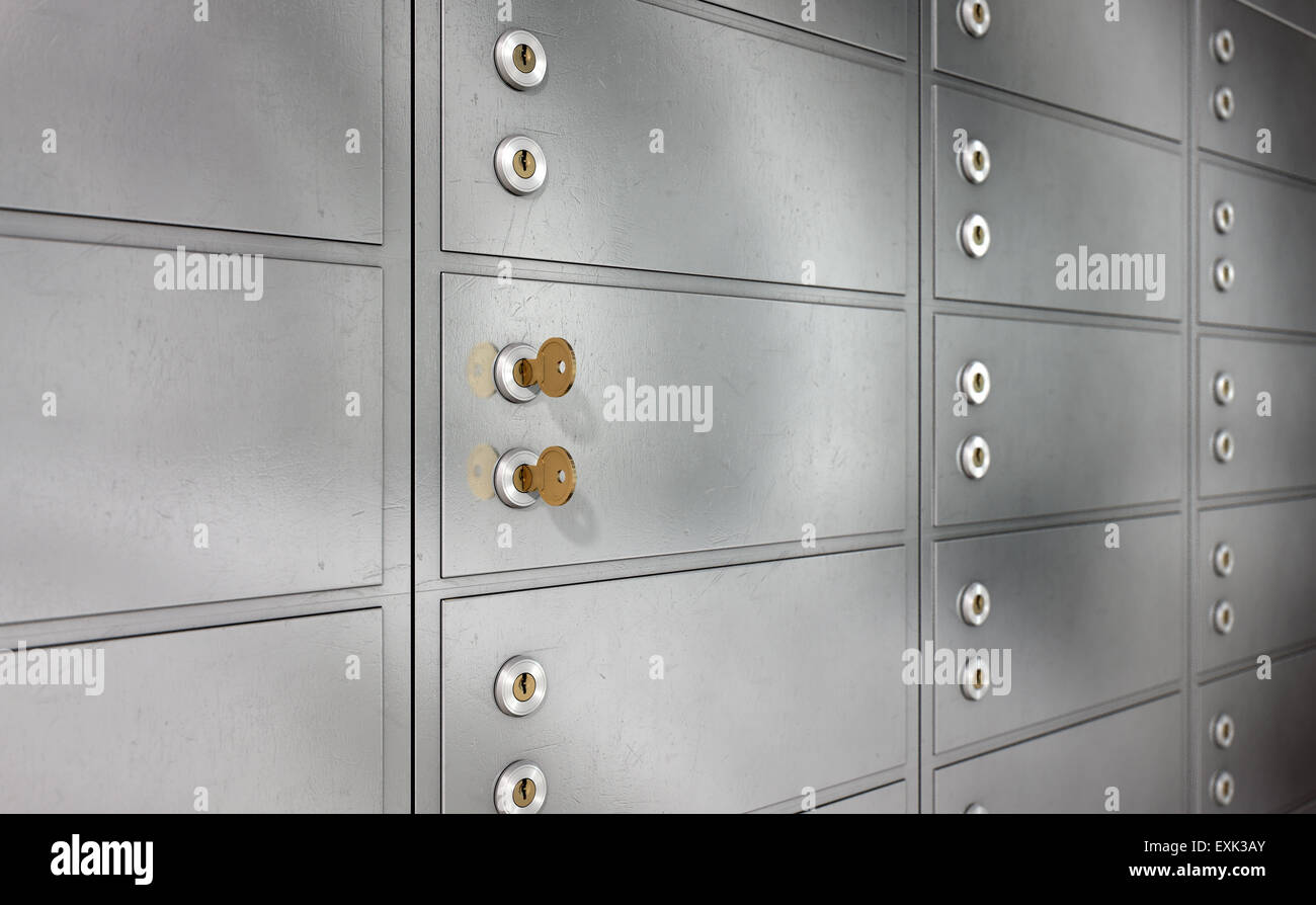 A closeup of a wall of closed metal safety deposit boxes and one with ...