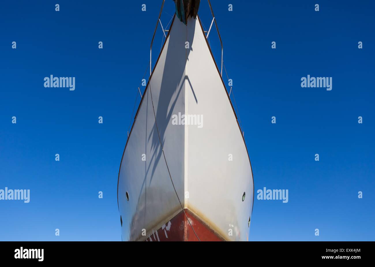 Close up of front side of big ship in port. Ship trunk on blue sky ...