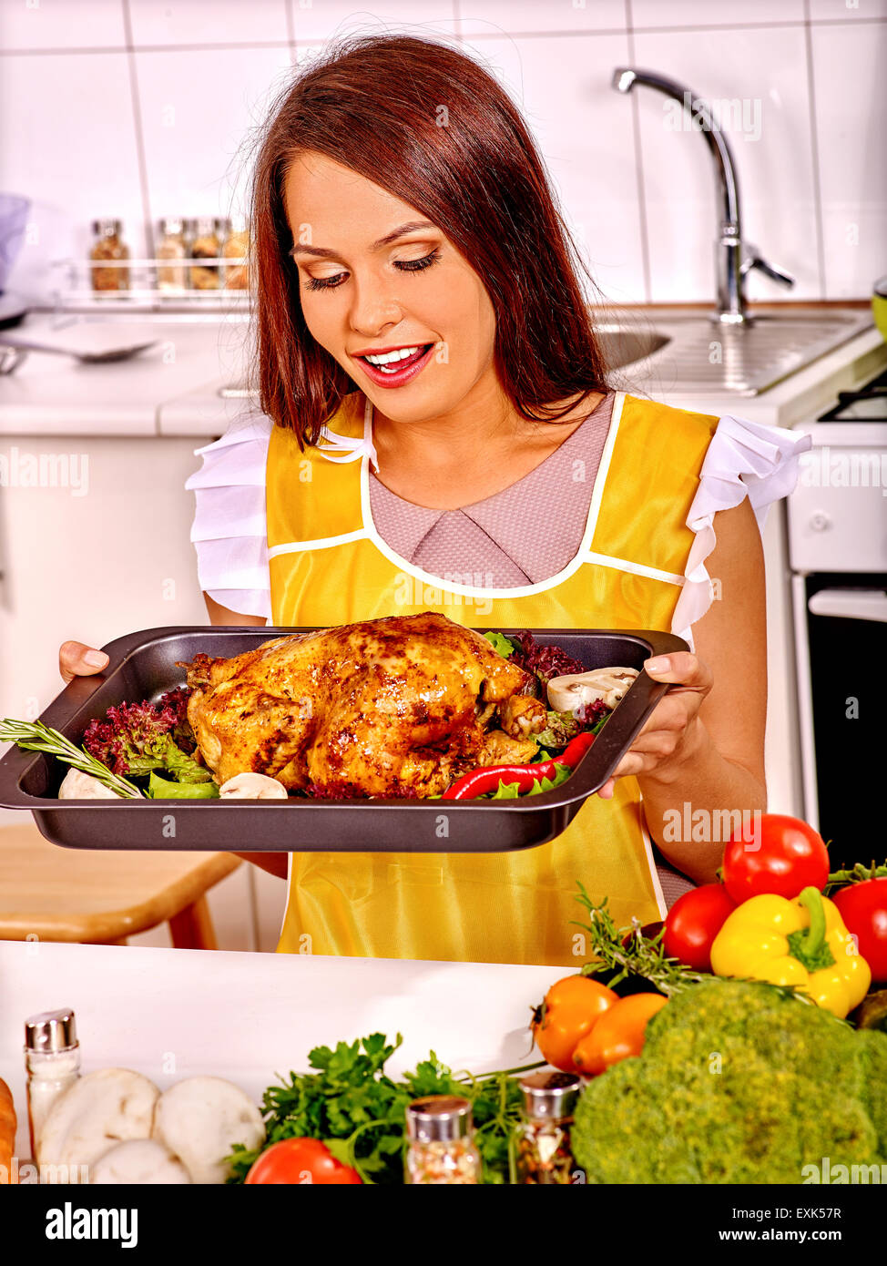 Woman cooking chicken at kitchen Stock Photo - Alamy