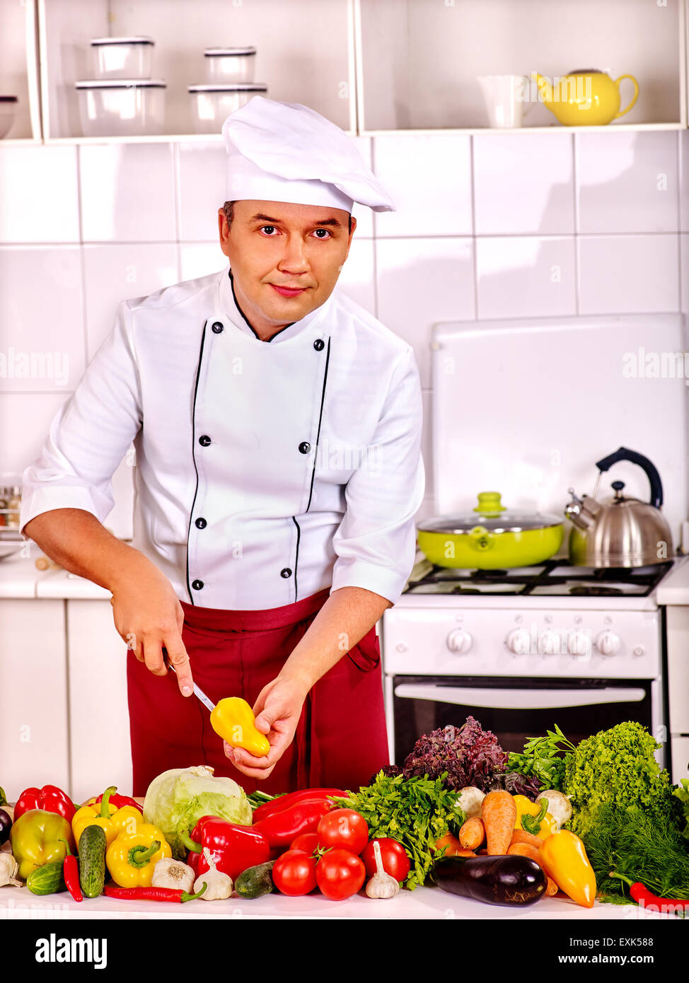 Man in chef hat cooking chicken Stock Photo - Alamy