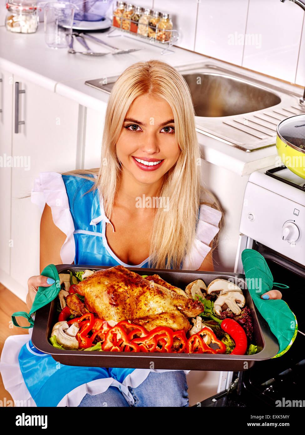 Woman cooking chicken at kitchen Stock Photo - Alamy