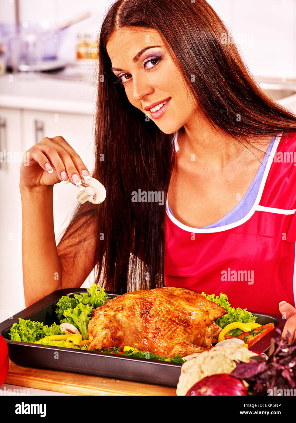 Woman cooking chicken at kitchen Stock Photo - Alamy