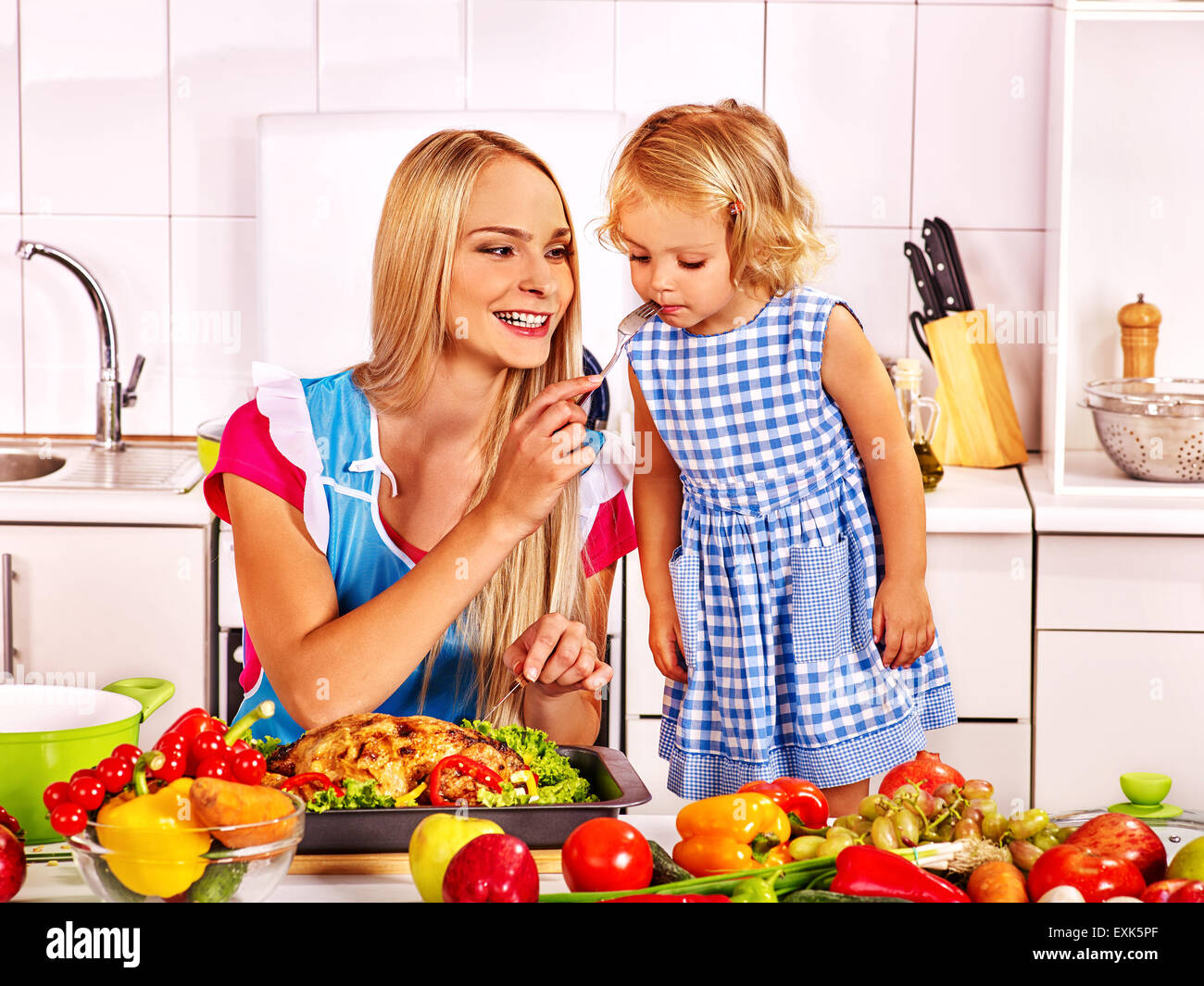 Mother feed child at kitchen Stock Photo - Alamy