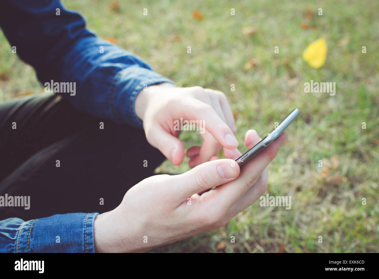 Young man using iphone hi-res stock photography and images - Alamy