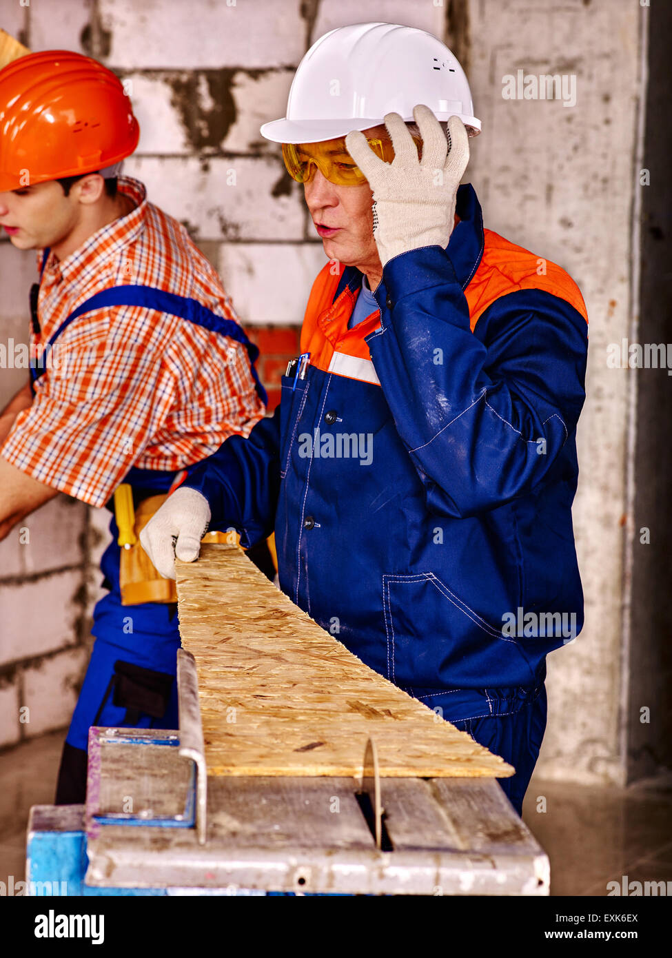 Group people builder with circular saw Stock Photo - Alamy